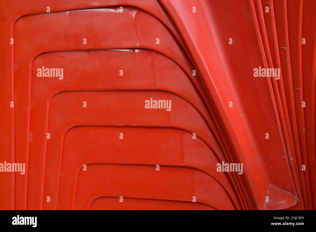 color abstract on the red stacks of plastic chairs Stock Photo - Alamy