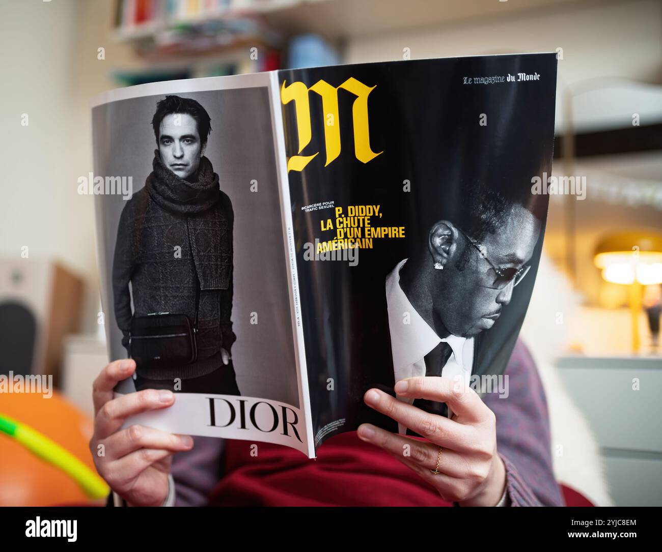 Paris, France - Nov 13, 2024: Person reading Le Monde Magazine ...