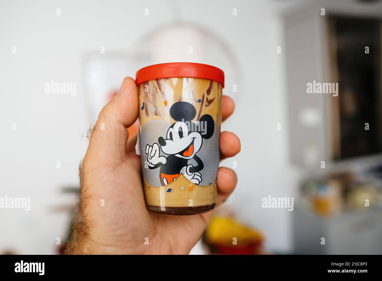 Haarlem, Netherlands - Sep 6, 2024: A hand holds a peanut butter jar ...
