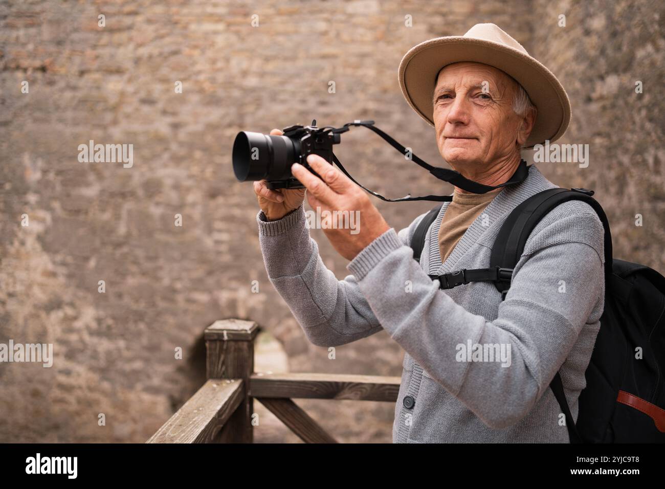 Retired man photographing ancient fortress with camera Stock Photo - Alamy