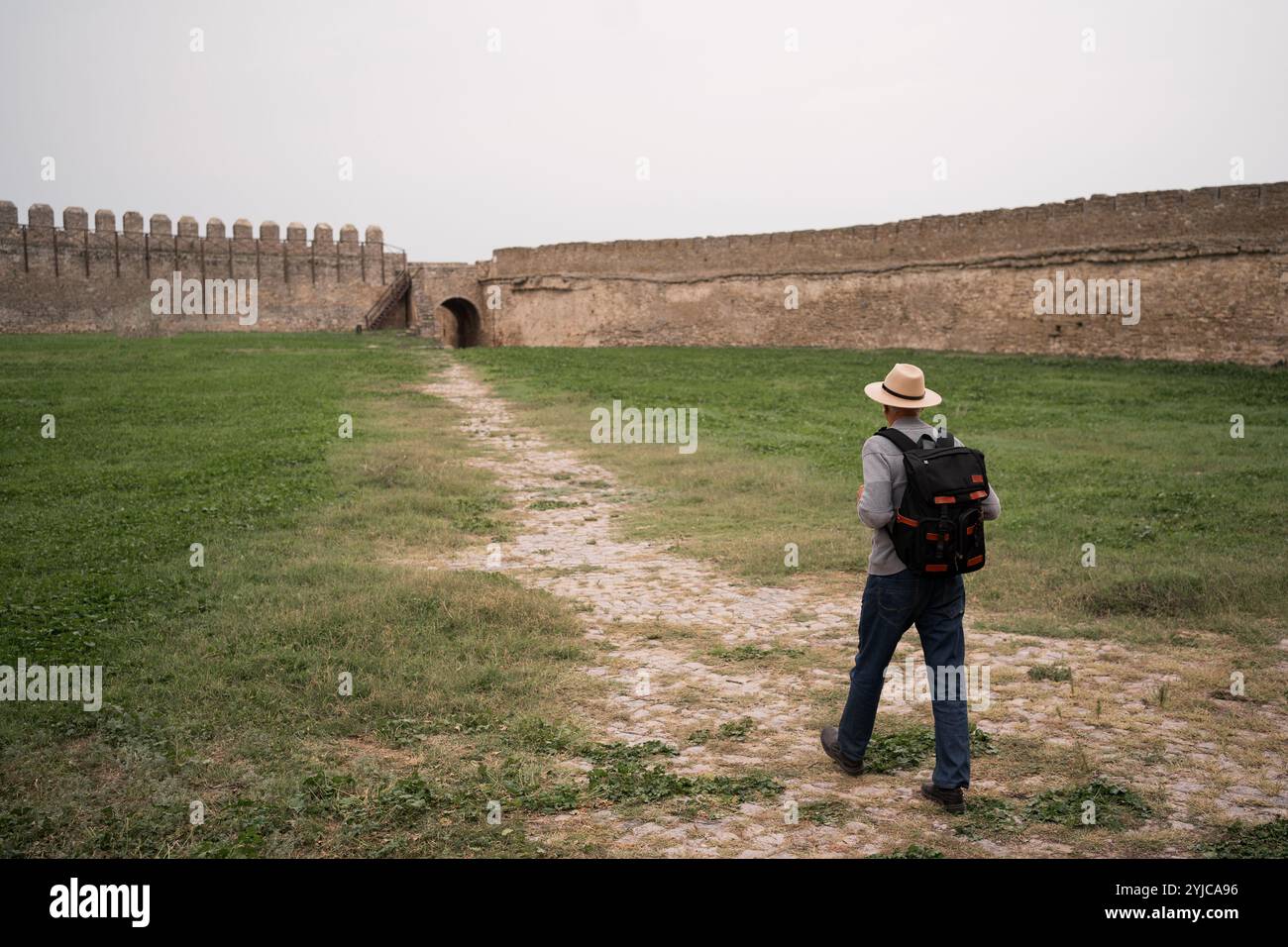 Happy older man walking in old fortress landscape. Retired person ...