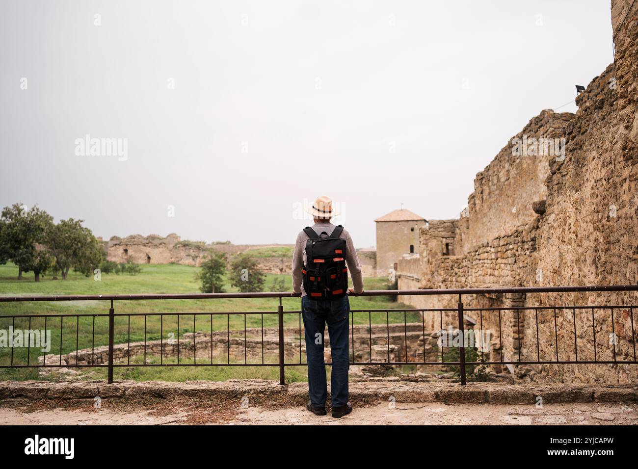 Retired man touring ancient fortress, marveling at cultural history and ...