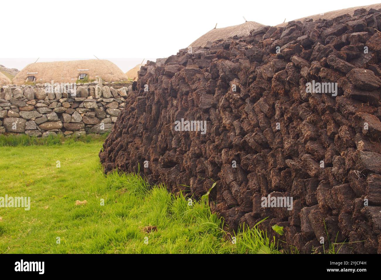 A huge stack, or cruach, of peat outside the black houses at the ...