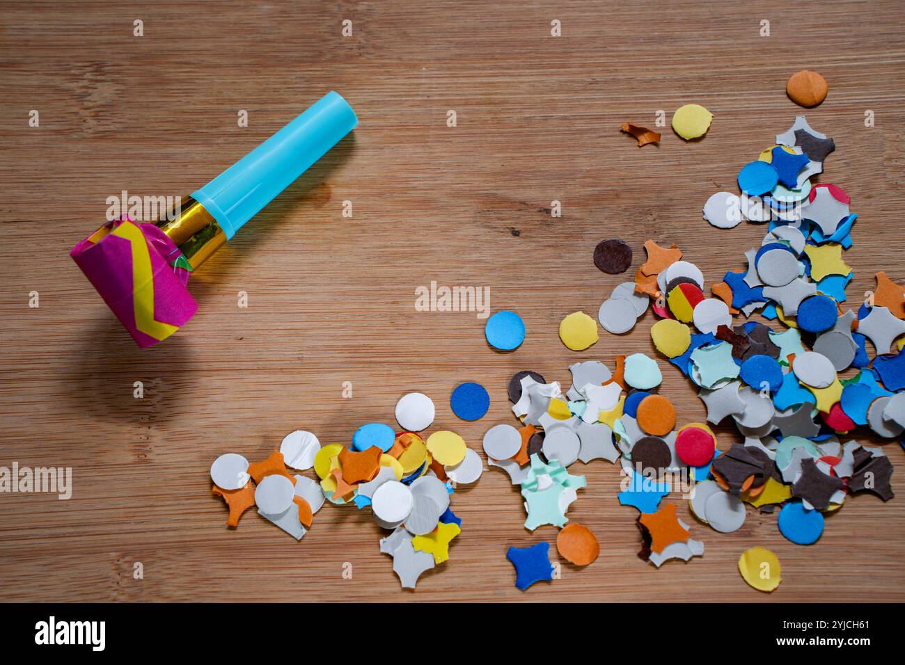 Party kazoo horn on colorful confetti stillife concept photo with text ...