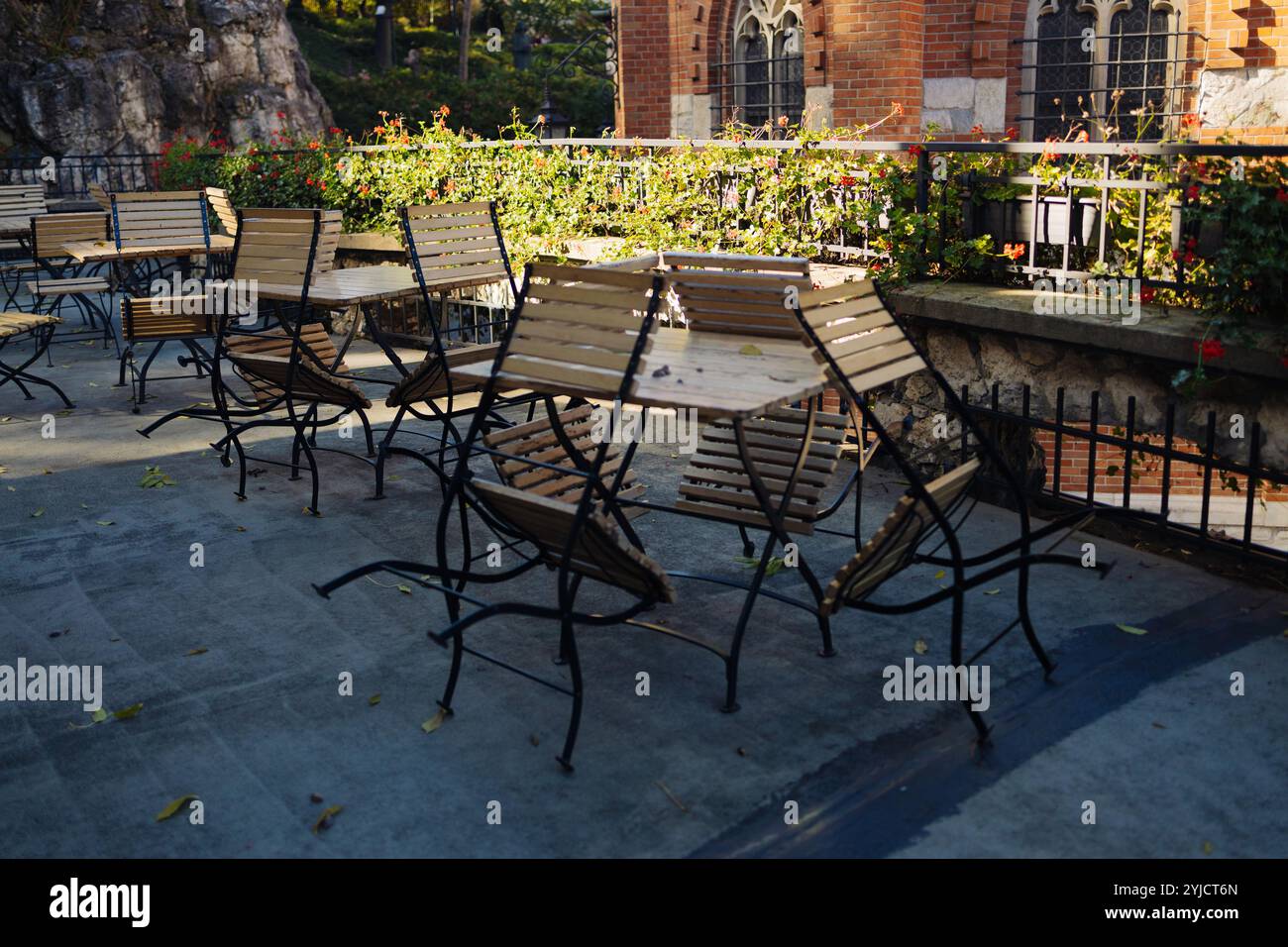 Outdoor cafe interior. simple, tasteful tables with chairs at city park ...