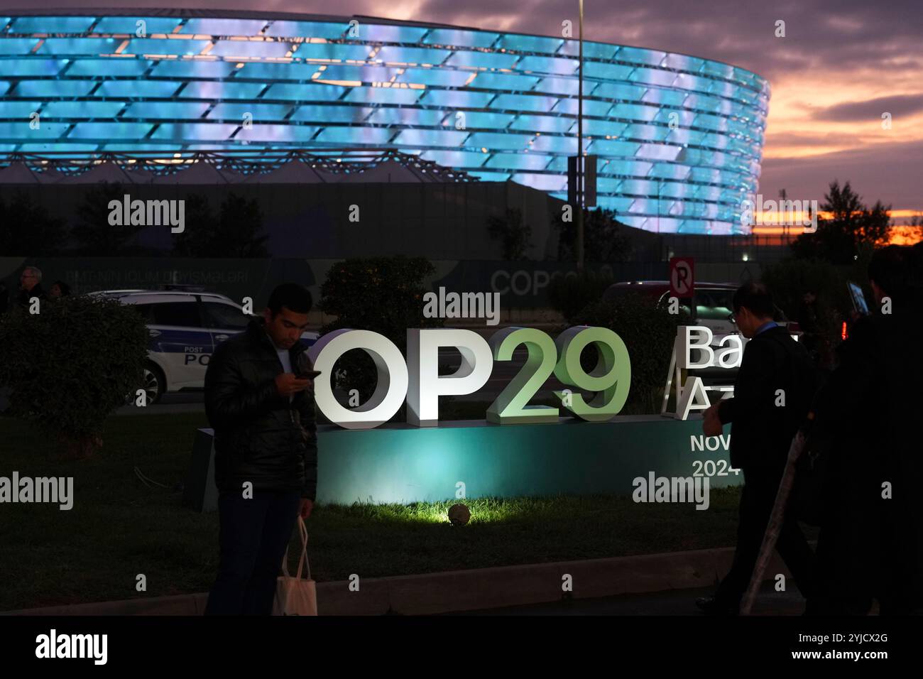 People walk outside the Baku Olympic Stadium during the COP29 U.N ...