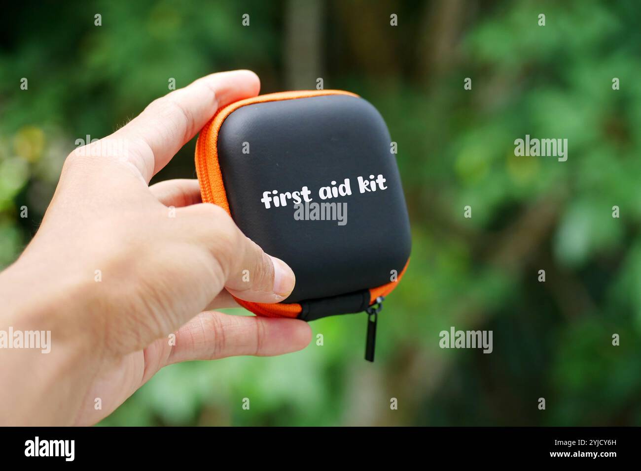 Hand holding small box bag for first aid. First aid kit Stock Photo - Alamy