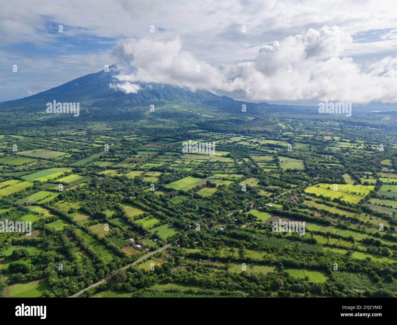 Landscape features expansive fields contrasting against towering ...