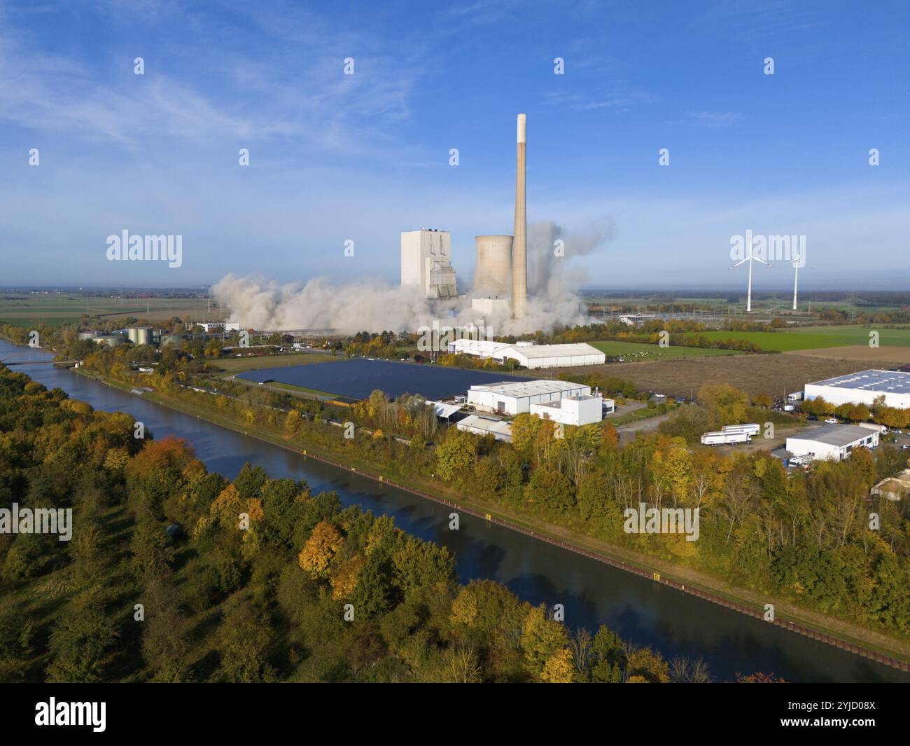 A coal-fired power station with smoking chimneys in a rural setting ...