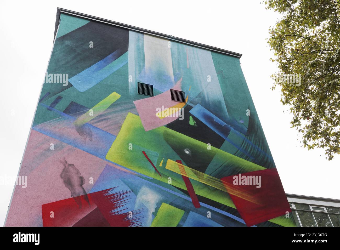 Abstract mural in bright colours on a school building, by graffiti ...