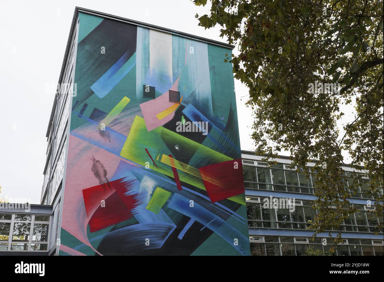 Abstract mural in bright colours on a school building, by graffiti ...