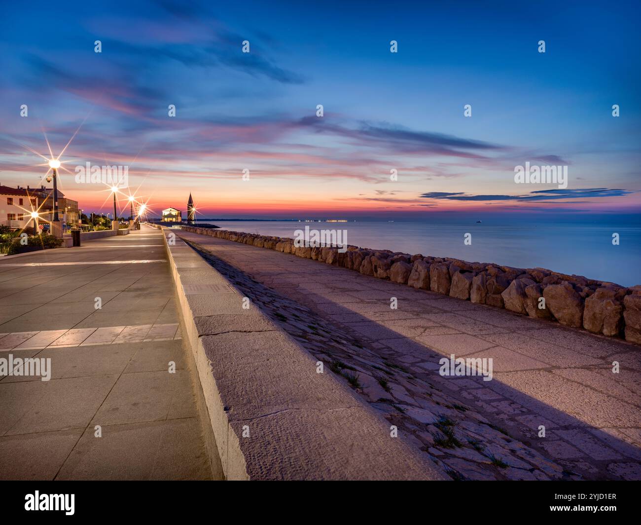 Landscape of the seafront in Caorle in Italy, with a small church ...