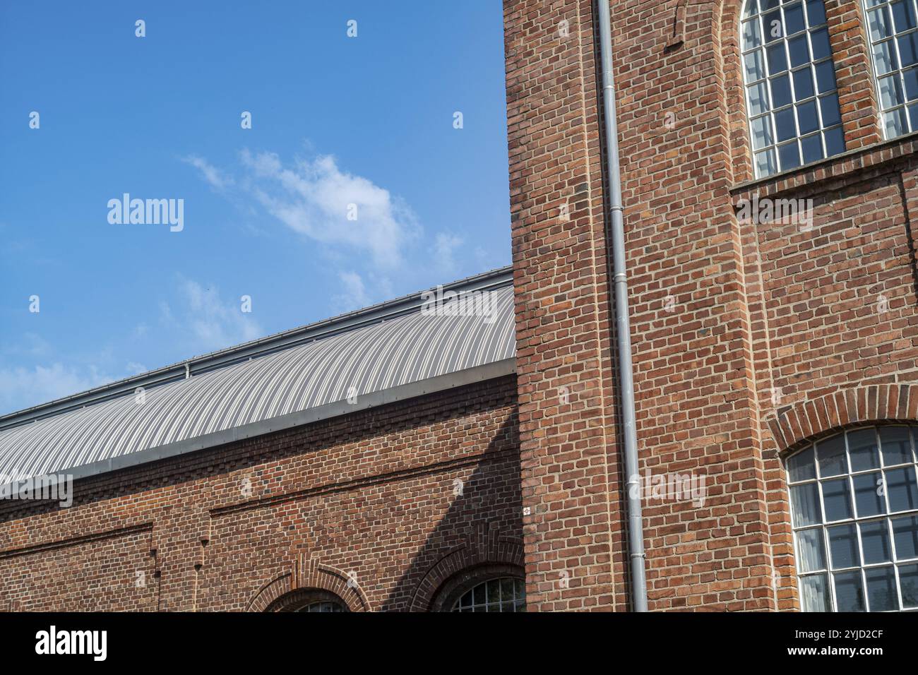 Upward view of a historic brick building with metal structures, Bottrop ...