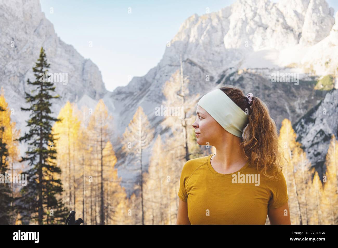 Waist up woman, fall autumn hiker girl outdoor in the forest fixing up ...