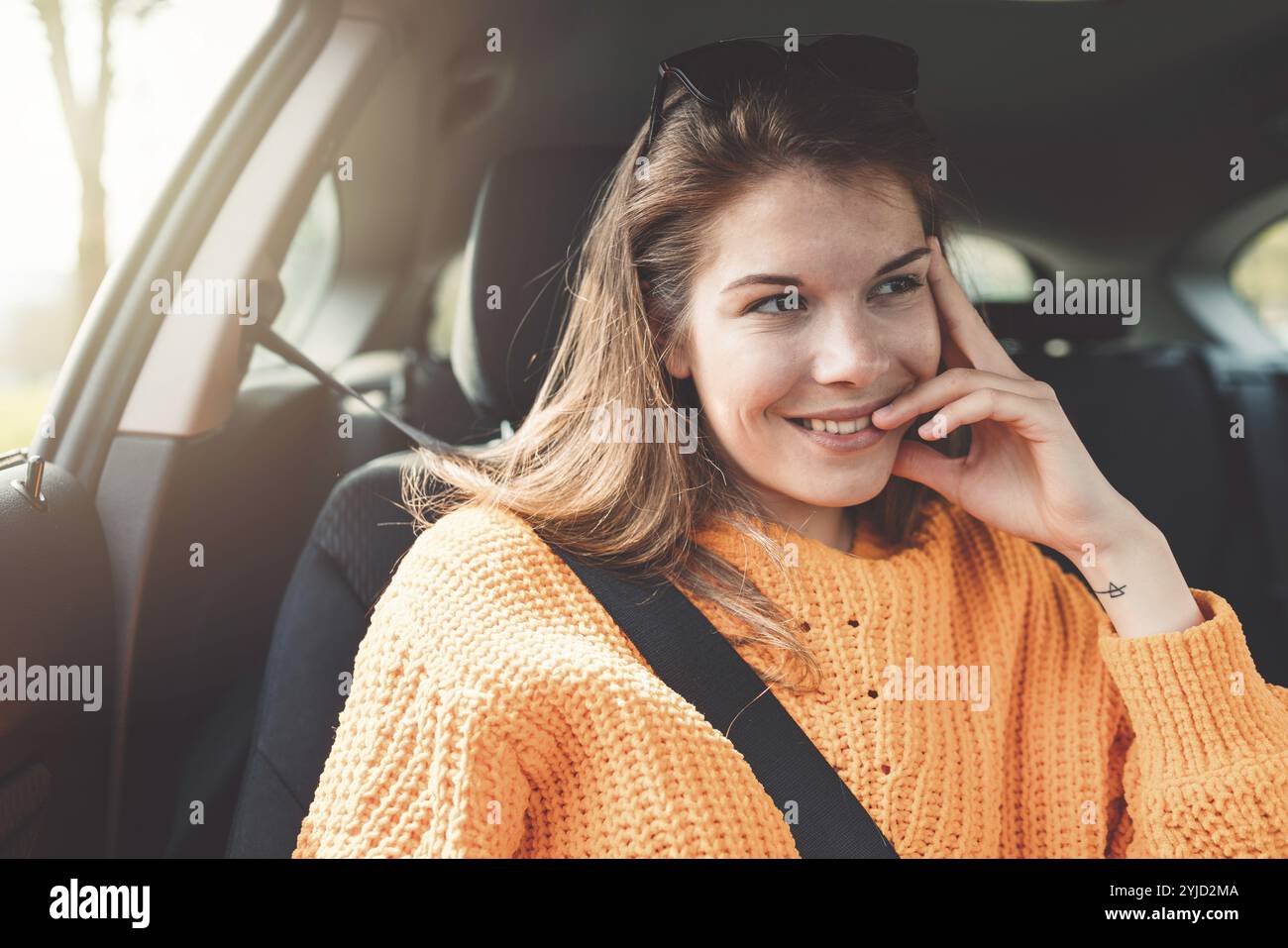 Beautiful young happy smiling caucasian woman driving in her car ...