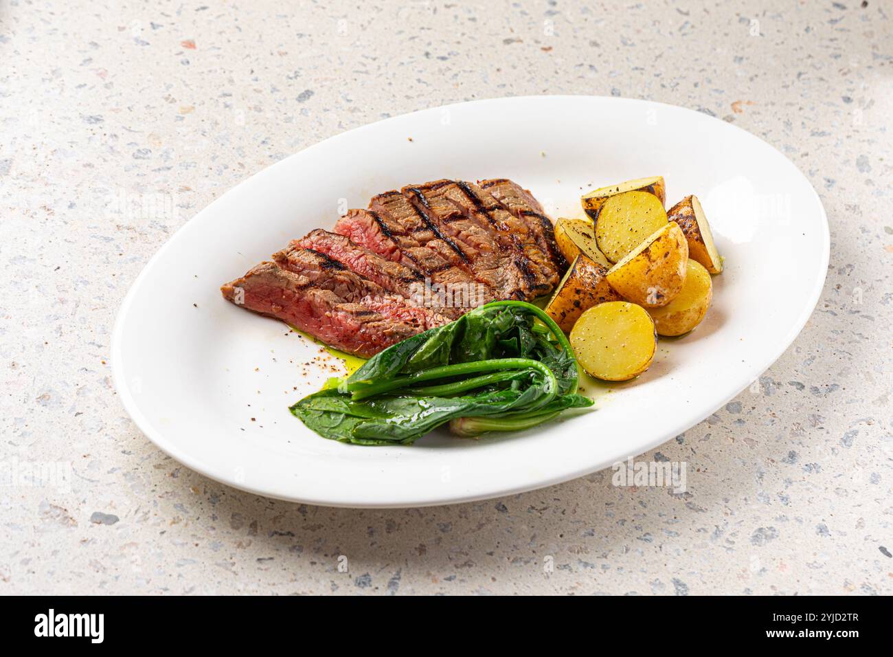 Portion of grilled top blade steak with potatoes Stock Photo - Alamy