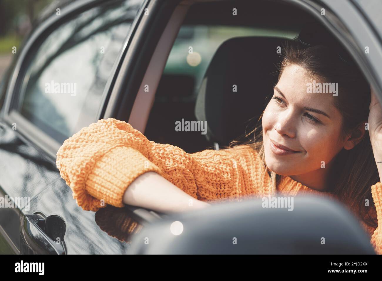 Beautiful young happy smiling caucasian woman driving in her car ...