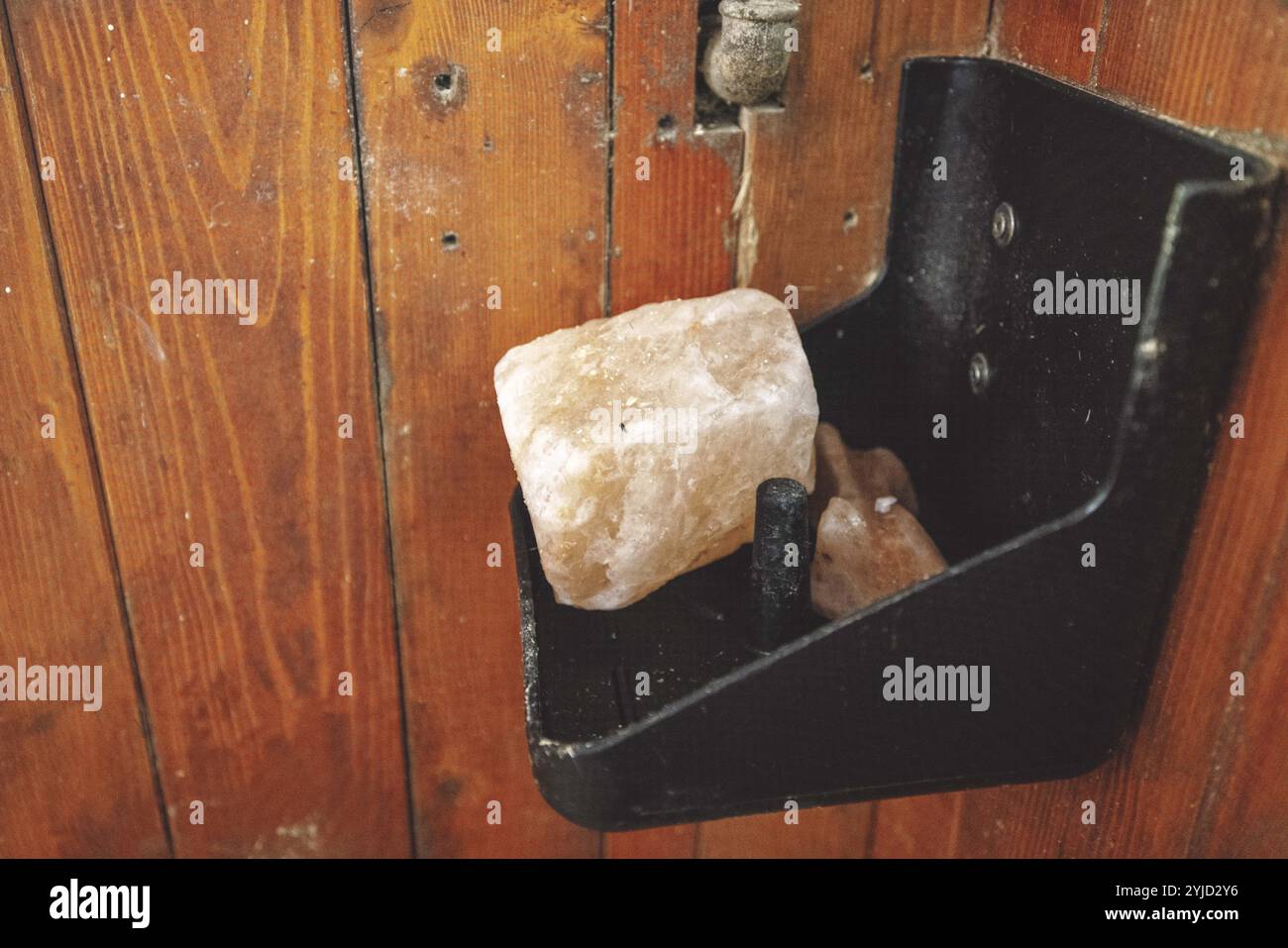 Rock salt for the horse to lick inside the horse stable on a shelf ...