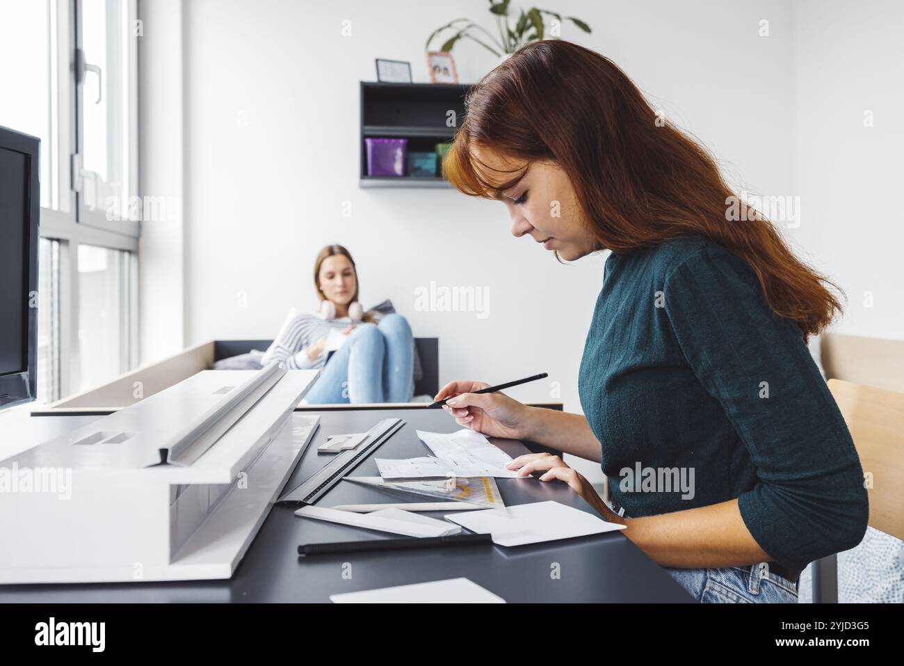 Two young caucasian women, college students studying together in their ...