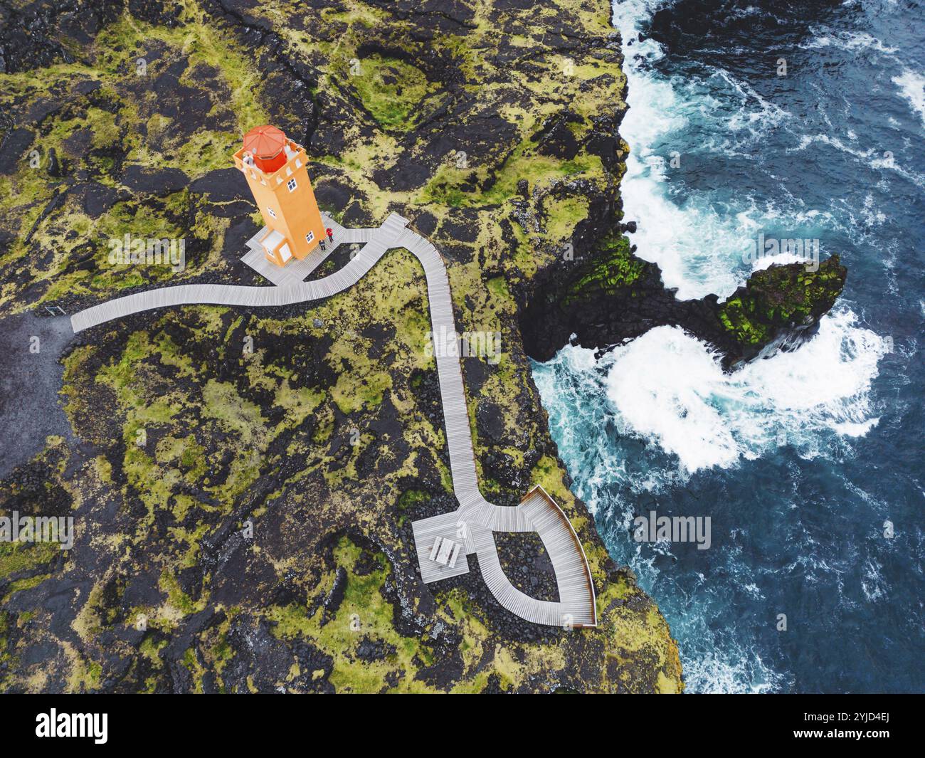 View of orange Svortuloft Lighthouse by the sea in West Iceland ...