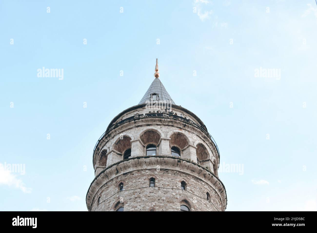 Historical stone tower with a spire against a clear blue sky Stock ...