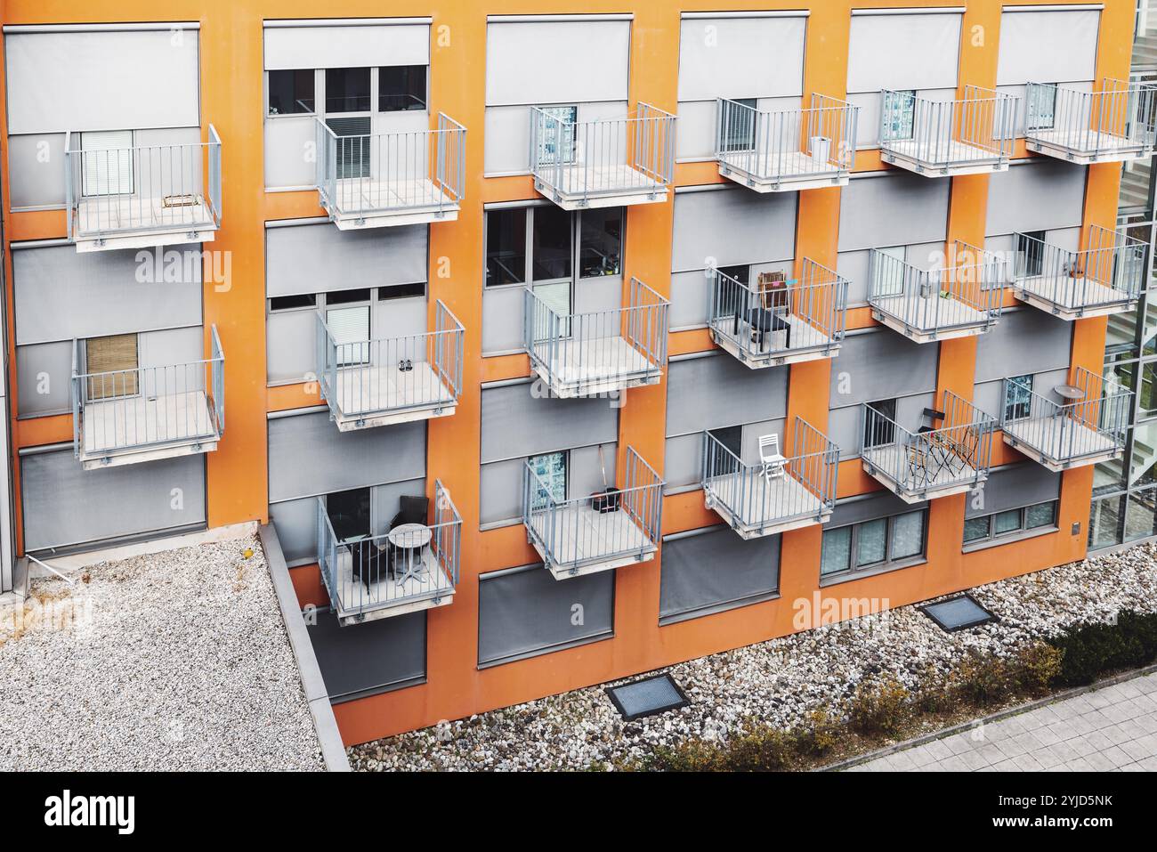 College dorm from outside, view of an orange building with grey ...