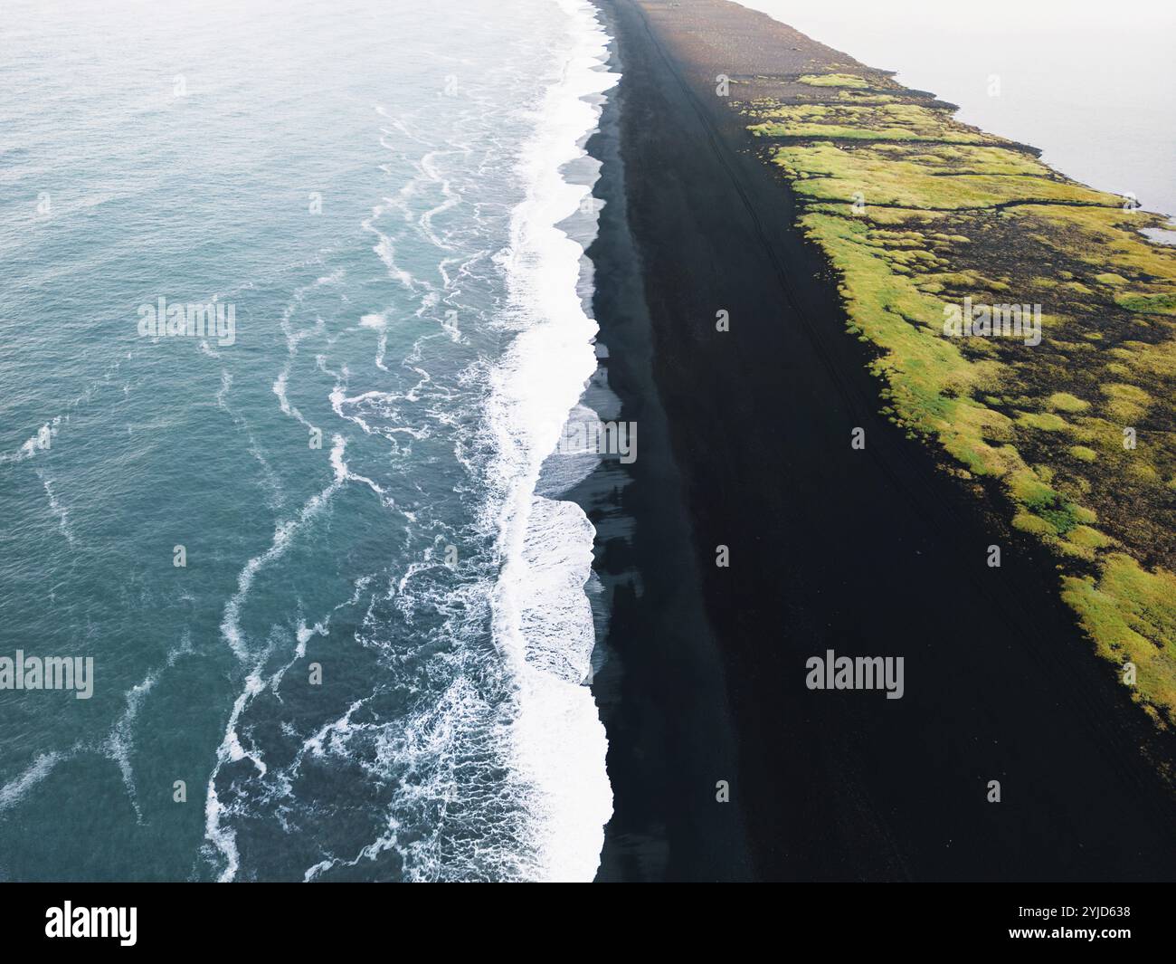 Volcanic Black Sand Beach with a view of Reynisdrangar. Waves crashing ...