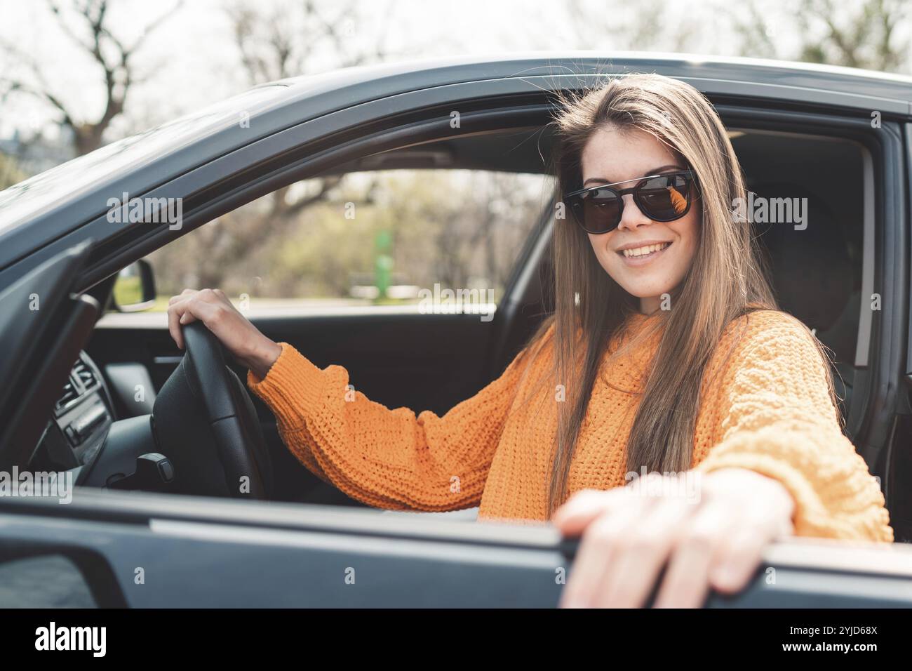 Beautiful young happy smiling caucasian woman driving in her car ...