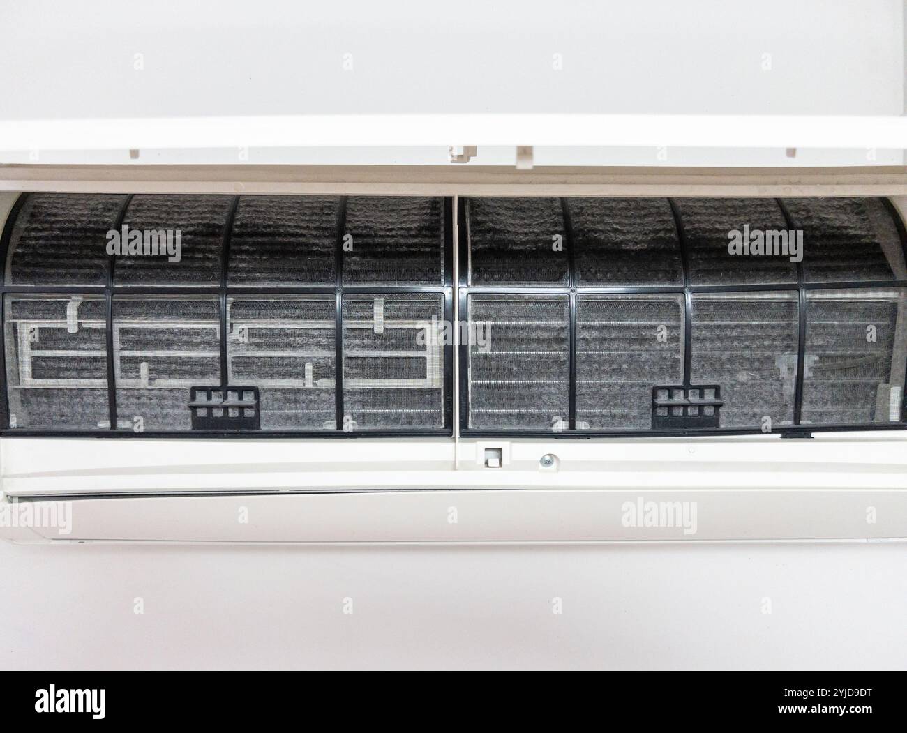The dirty air filter is full of dust in the air conditioning unit after ...