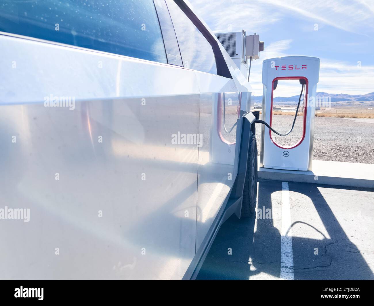 Side View of Tesla Cybertruck Charging at Supercharger Station Stock ...
