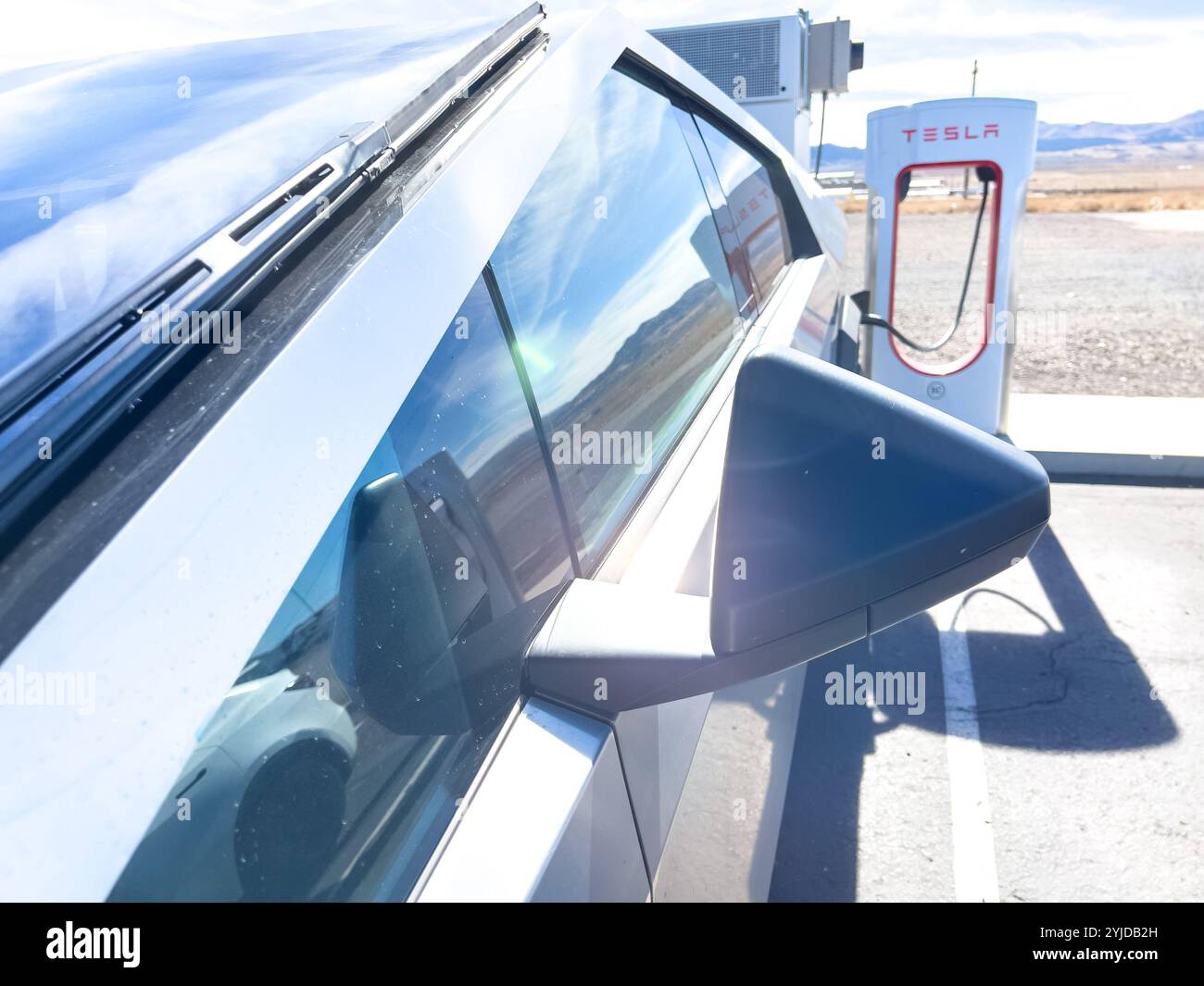 Side View of Tesla Cybertruck Charging at Supercharger Station Stock ...