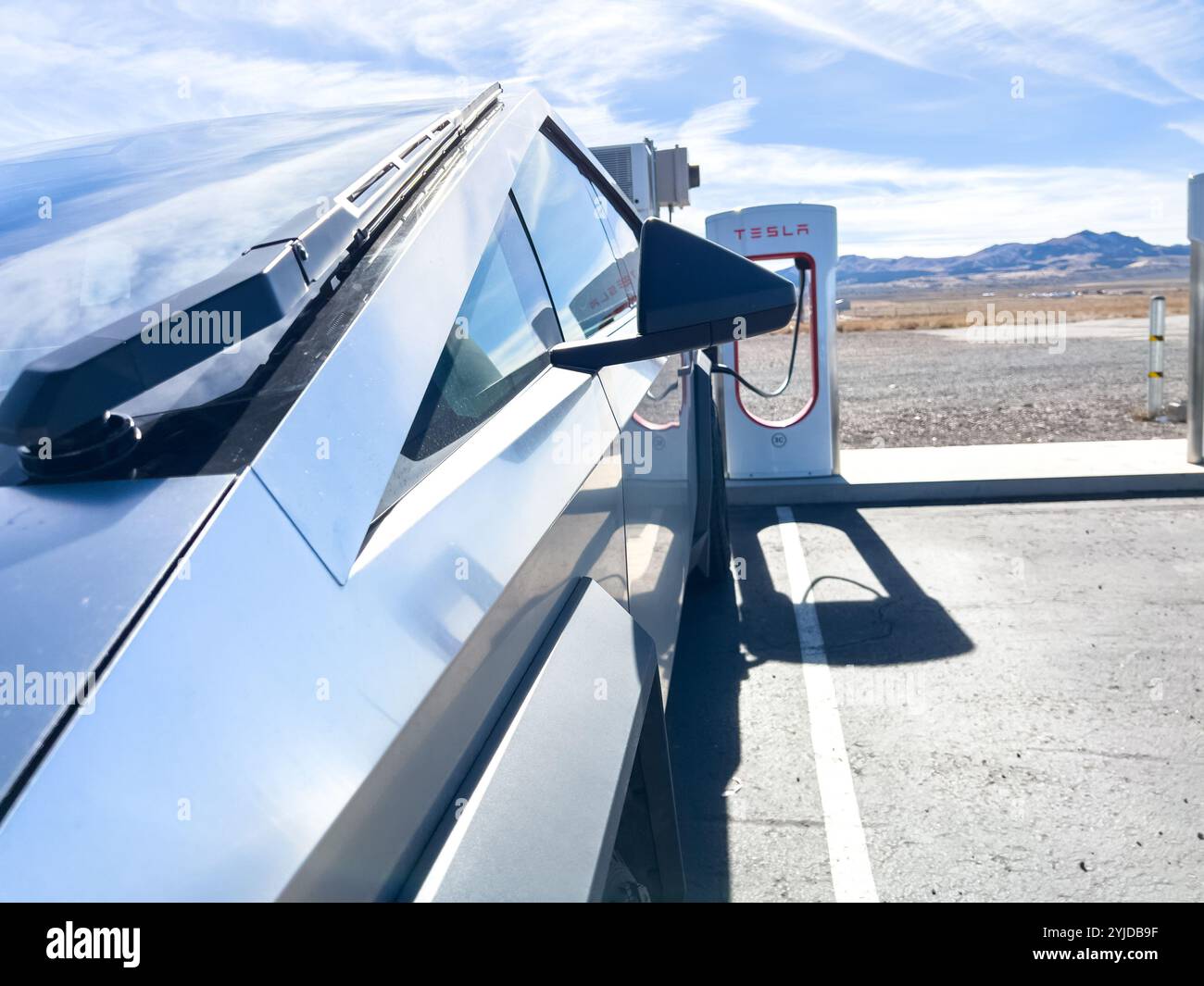 Side View of Tesla Cybertruck Charging at Supercharger Station Stock ...