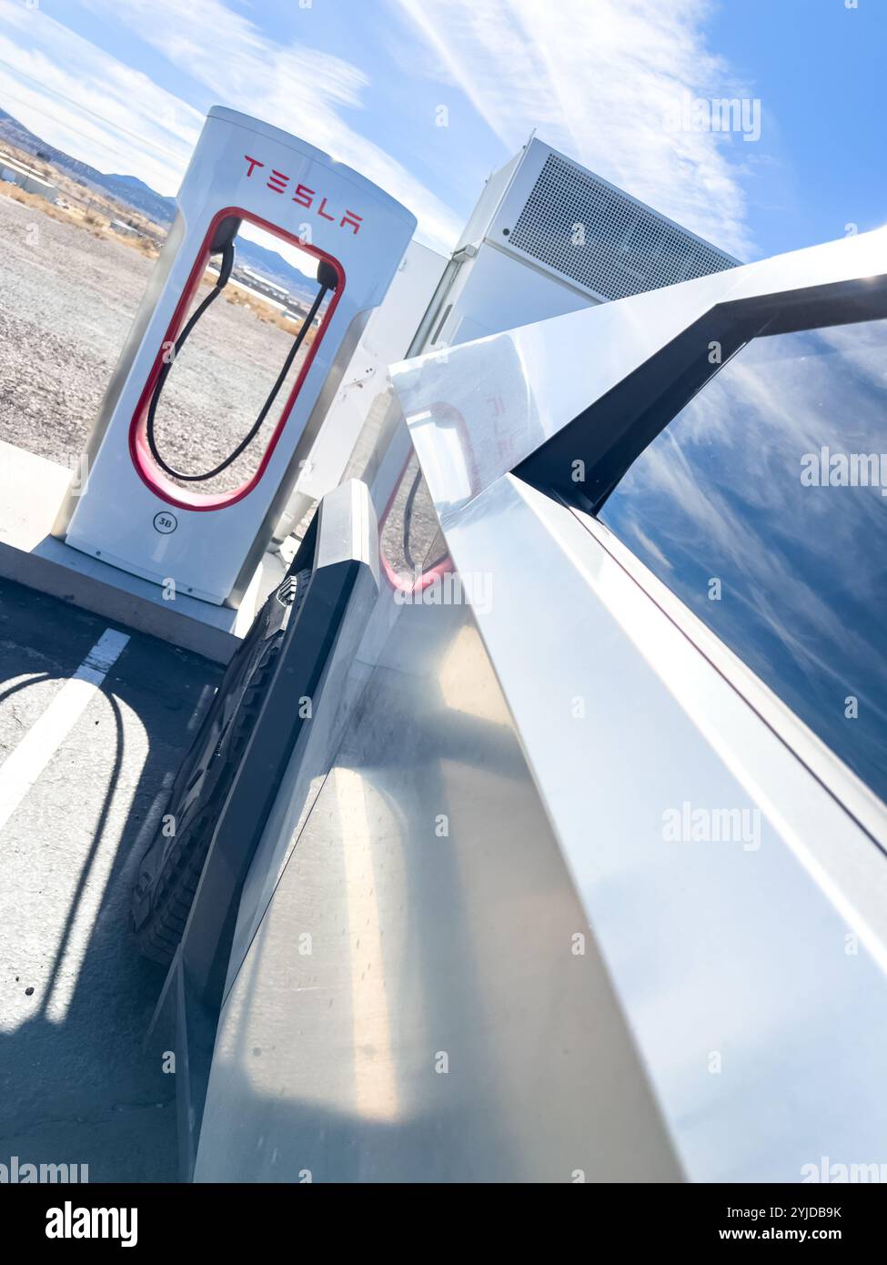 Side View of Tesla Cybertruck Charging at Supercharger Station Stock ...