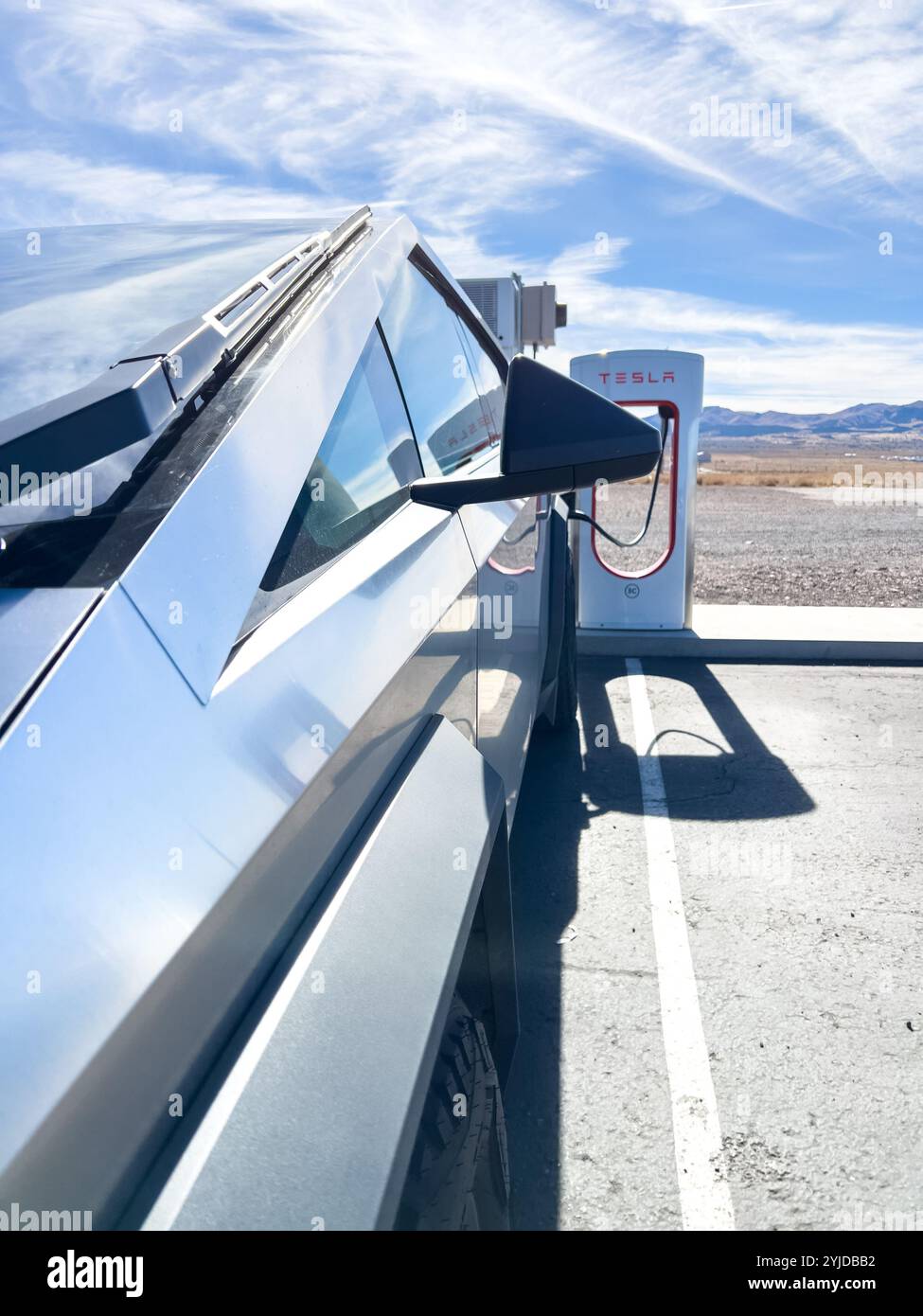 Side View of Tesla Cybertruck Charging at Supercharger Station Stock ...