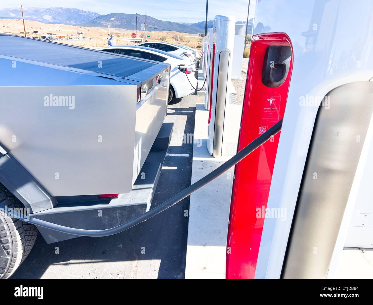 Side View of Tesla Cybertruck Charging at Supercharger Station Stock ...