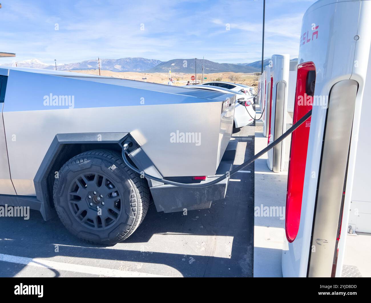 Side View of Tesla Cybertruck Charging at Supercharger Station Stock ...