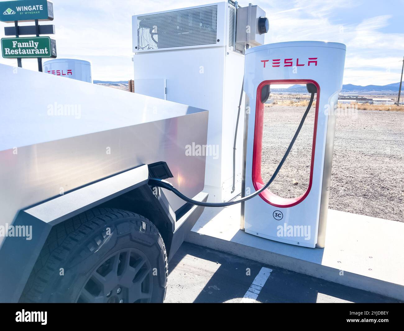 Side View of Tesla Cybertruck Charging at Supercharger Station Stock ...