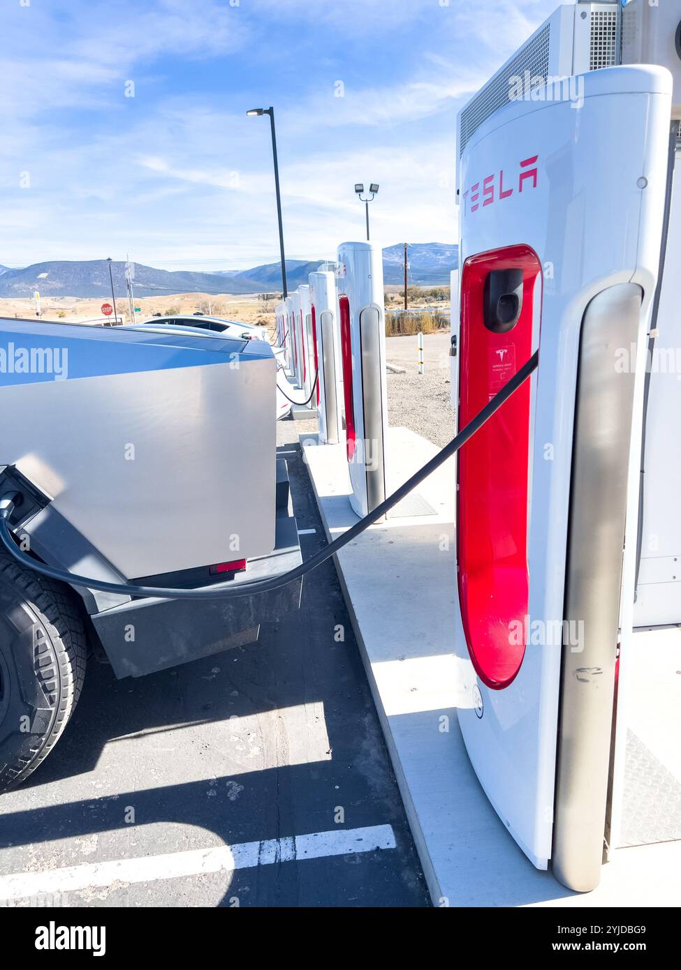 Side View of Tesla Cybertruck Charging at Supercharger Station Stock ...