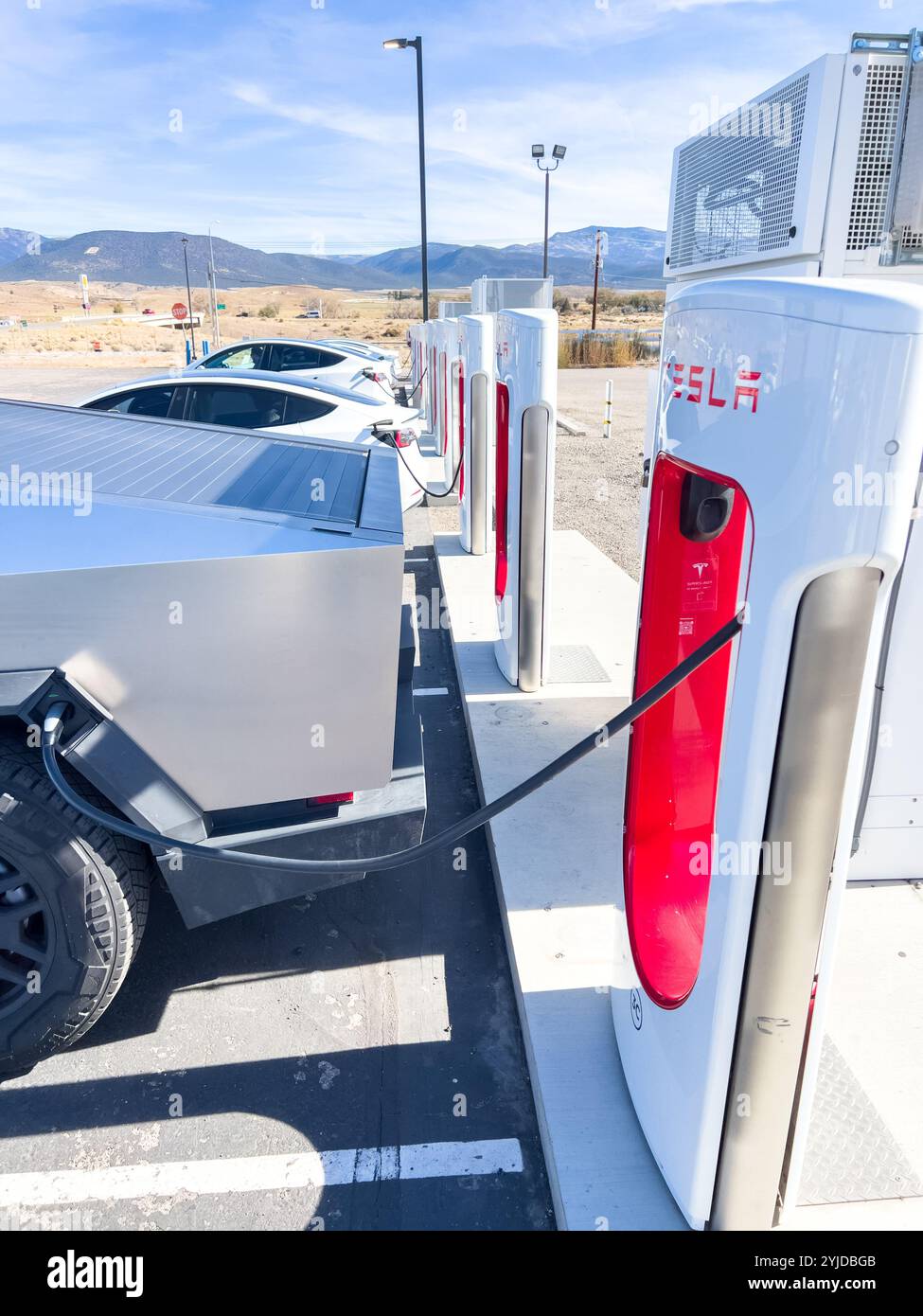 Side View of Tesla Cybertruck Charging at Supercharger Station Stock ...