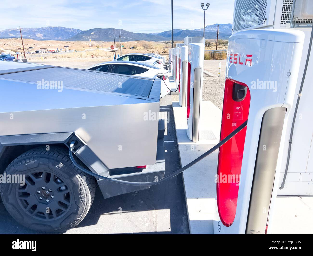 Side View of Tesla Cybertruck Charging at Supercharger Station Stock ...