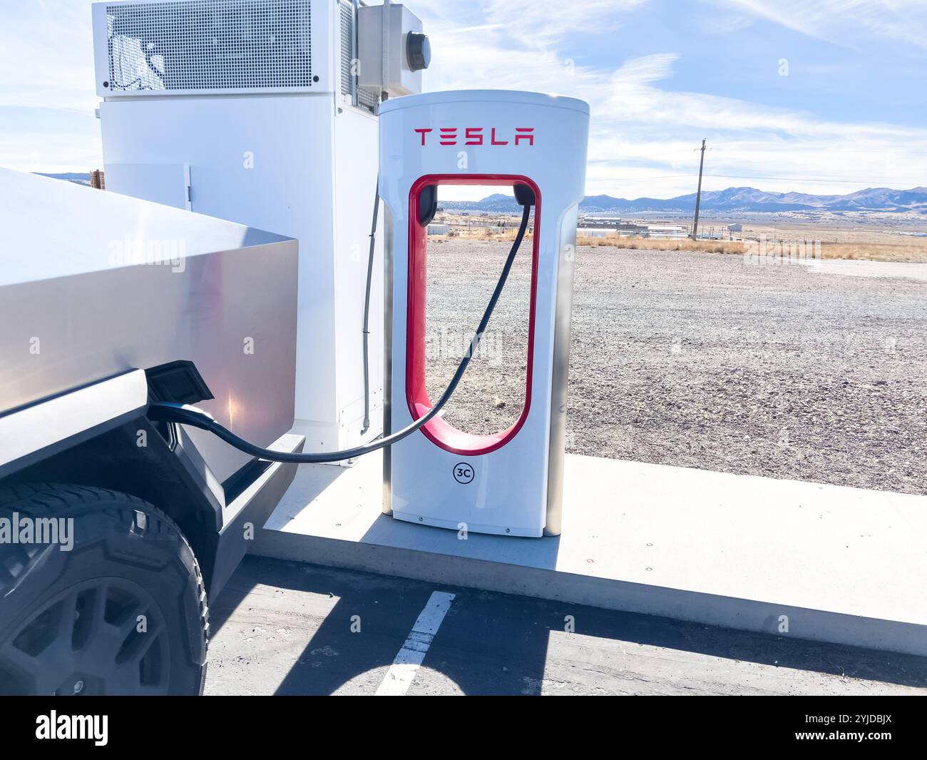 Side View of Tesla Cybertruck Charging at Supercharger Station Stock ...