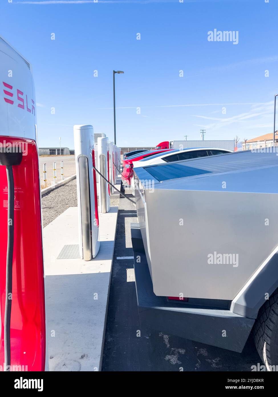 Side View of Tesla Cybertruck Charging at Supercharger Station Stock ...