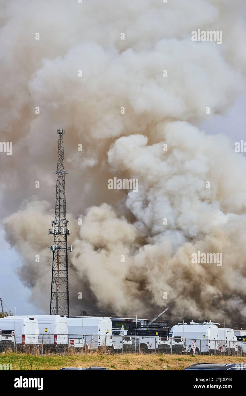 Massive Smoke Plume Over Scrap Metal Fire with Response Vehicles Eye ...