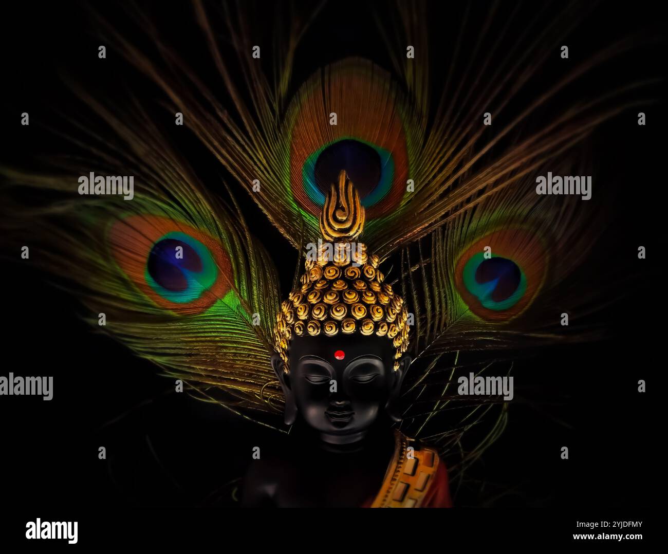 laughing buddha idol with peacock feather in the background.peaceful ...