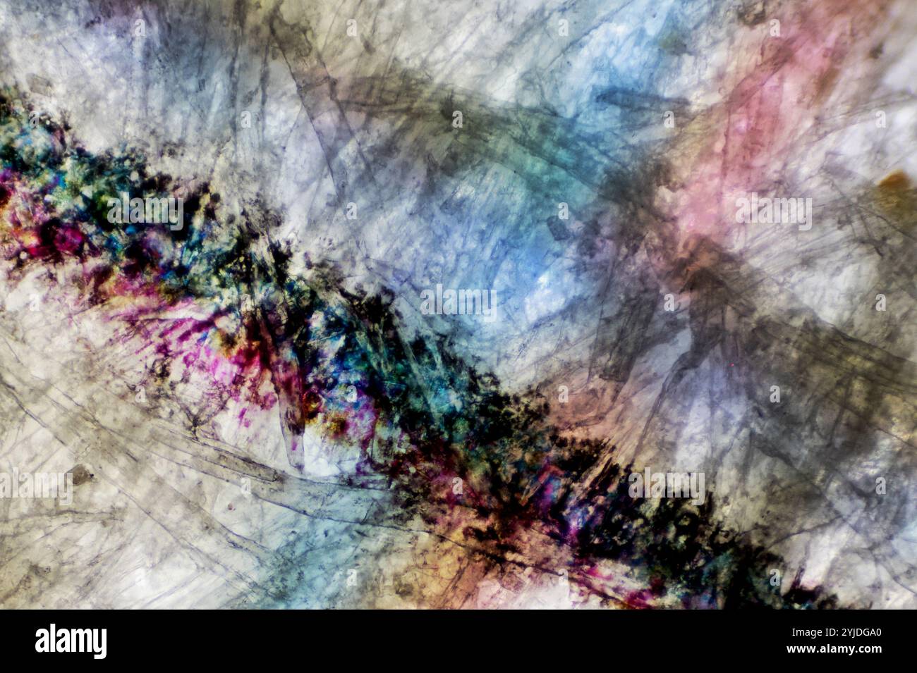 Coloured ink test lines on a newspaper, under a microscope at 10 times ...