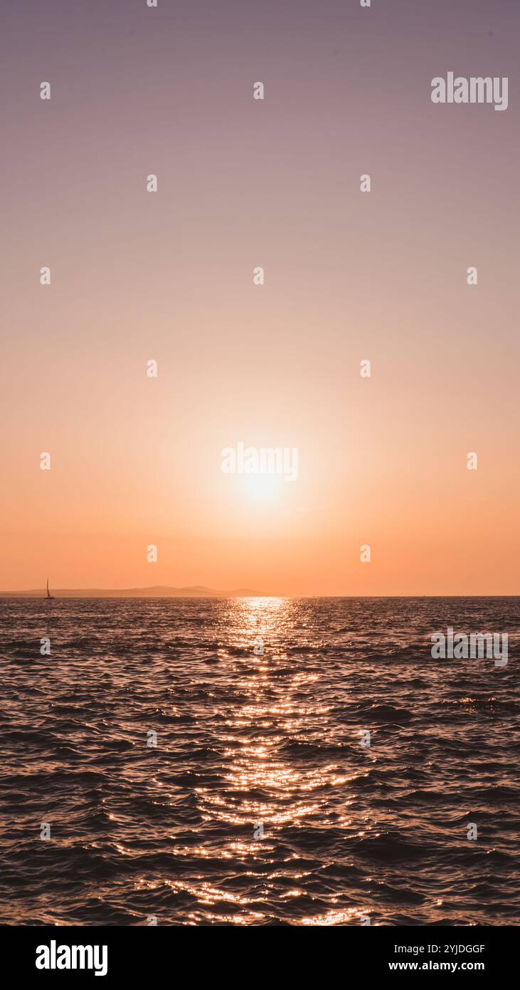 Serene sunset scene sailboat hi-res stock photography and images - Alamy