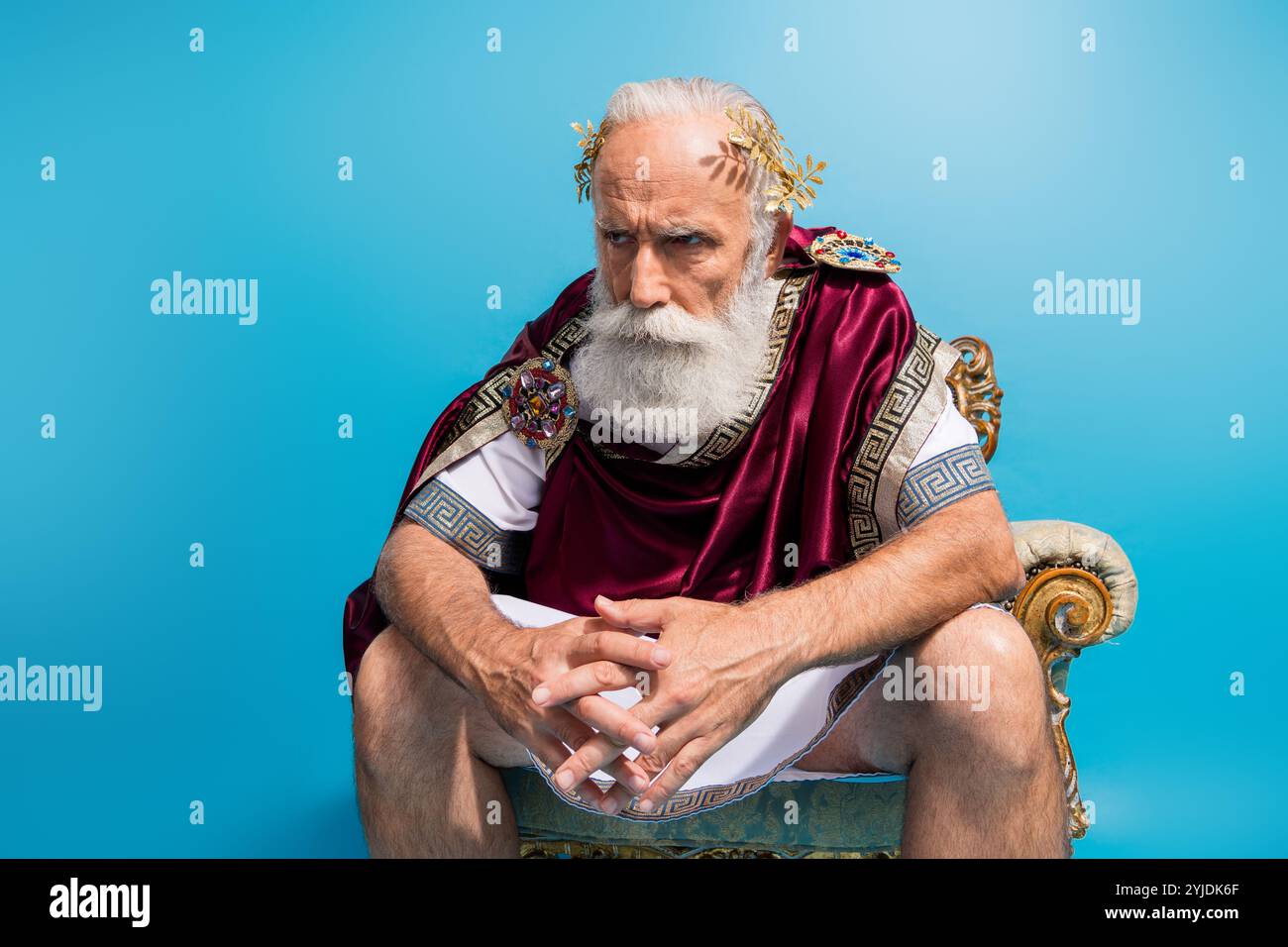 Photo of serious ancient leader teacher sit throne look empty space ...