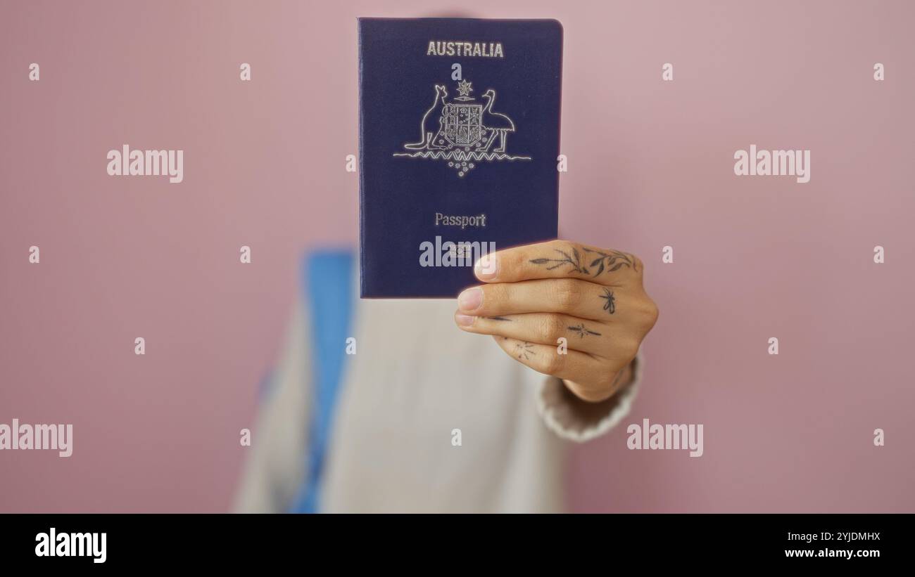 Woman holding australian passport with tattooed hand, isolated over ...