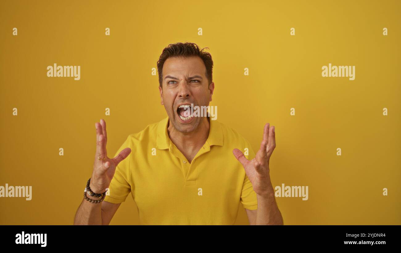 Man expressing frustration in a yellow shirt against a solid yellow ...
