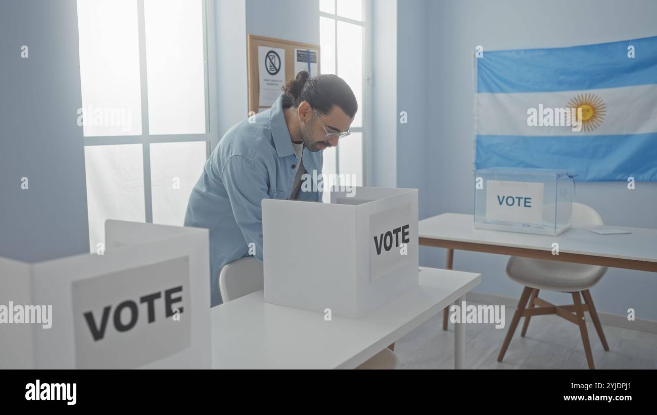 Young hispanic man voting in an argentinian electoral college room ...